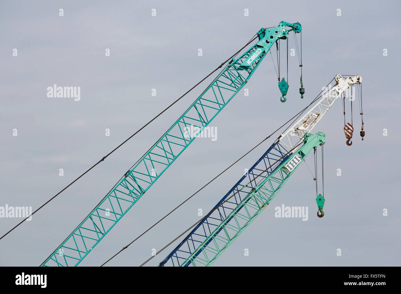 The top of tall crane arms showing the hook and lifting arm on a ...