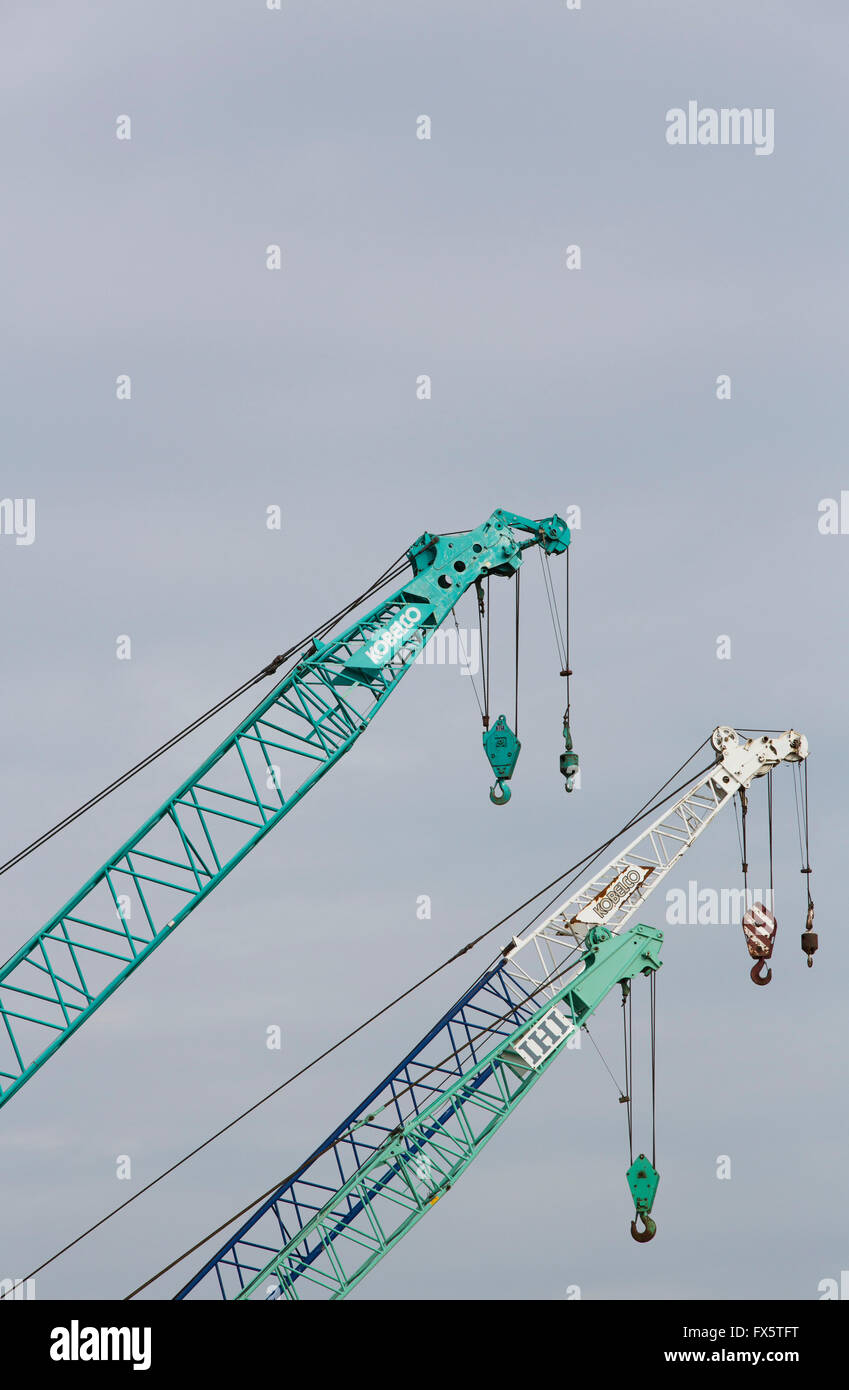 The top of tall crane arms showing the hook and lifting arm on a ...