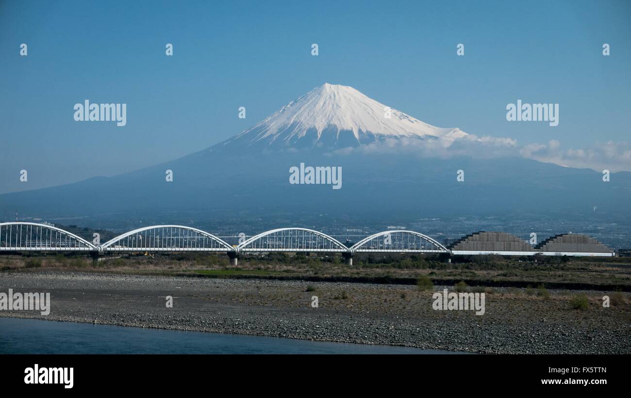 Snowcapped Mt. Fuji towering above the Shinkansen high speed railway ...