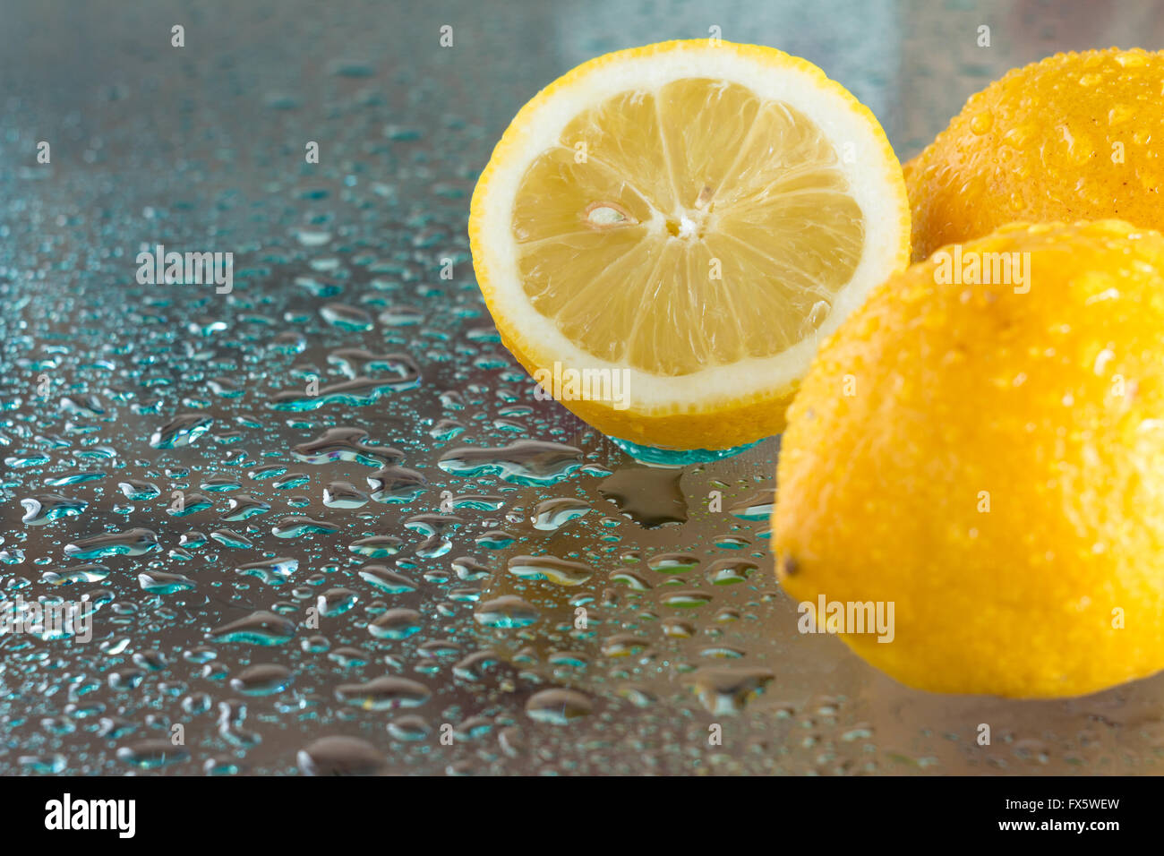 wet lemons on a glass surface Stock Photo - Alamy