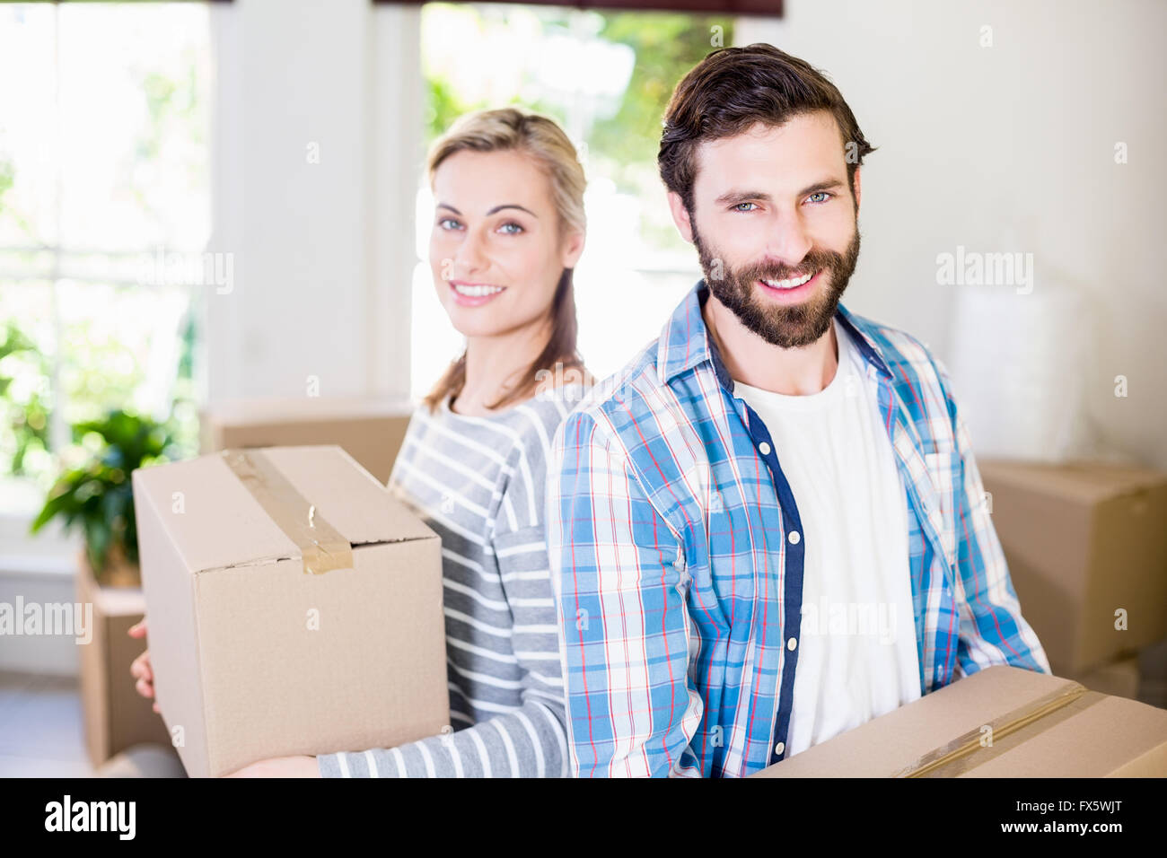 Portrait caucasian couple standing cardboard hi-res stock photography ...
