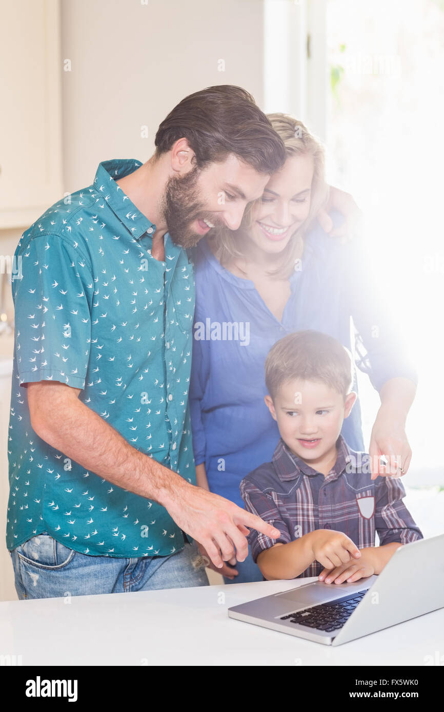 Happy parents and son using laptop Stock Photo - Alamy