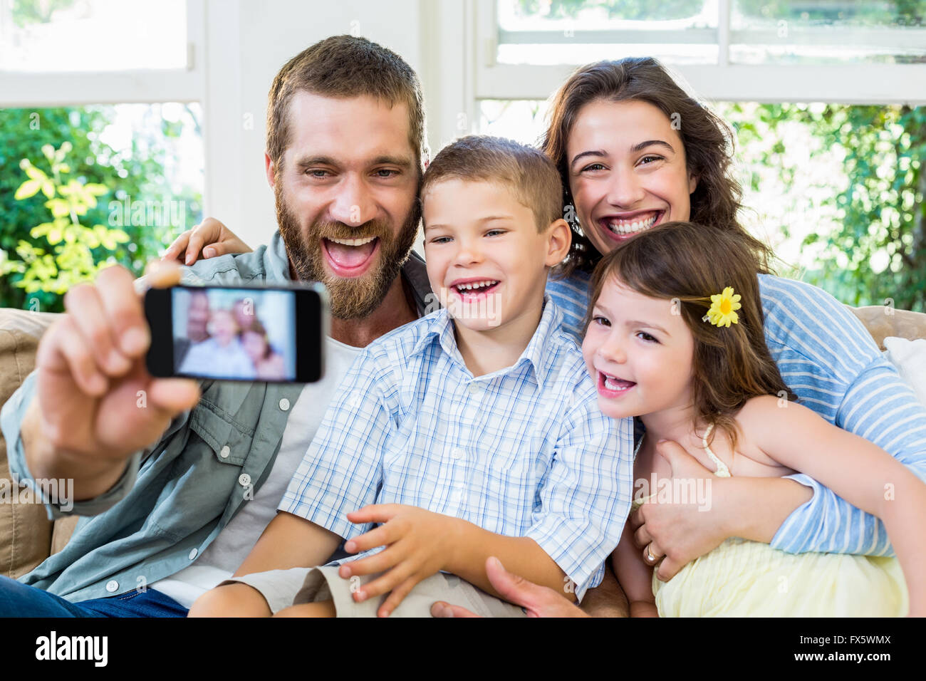Smiling family taking selfie Stock Photo - Alamy