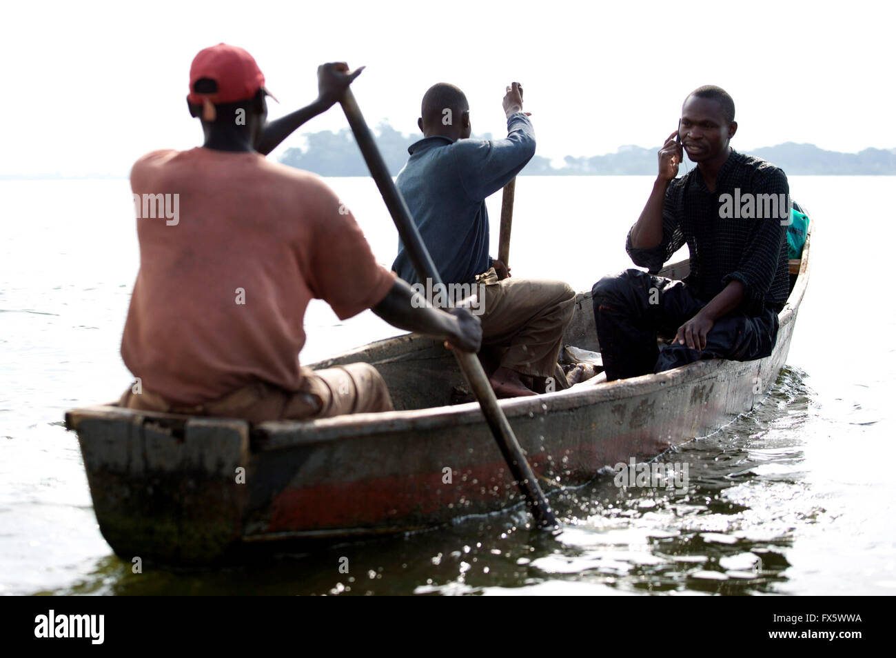 Men paddling in dug out canoe on lake Victoria, Uganda, Africa Stock ...