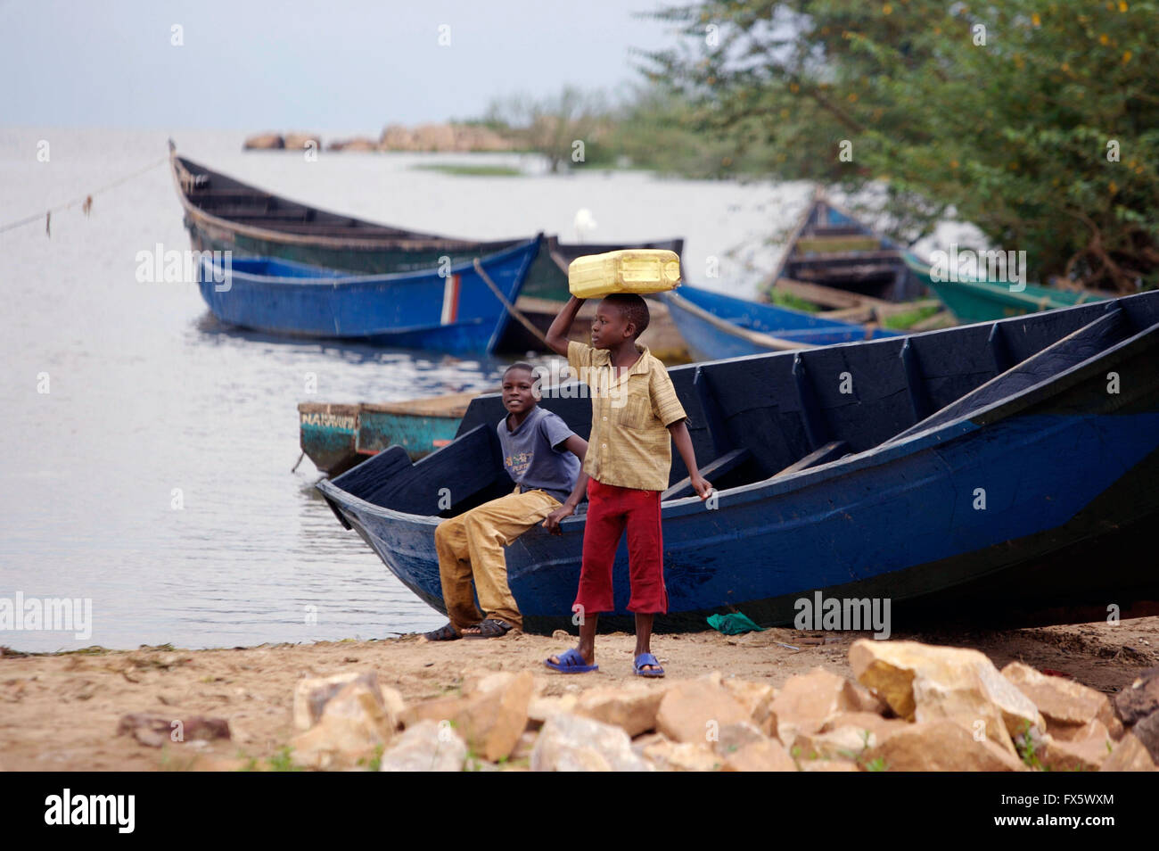 Children collecting water in Jerrycans from lake Victoria in Uganda ...