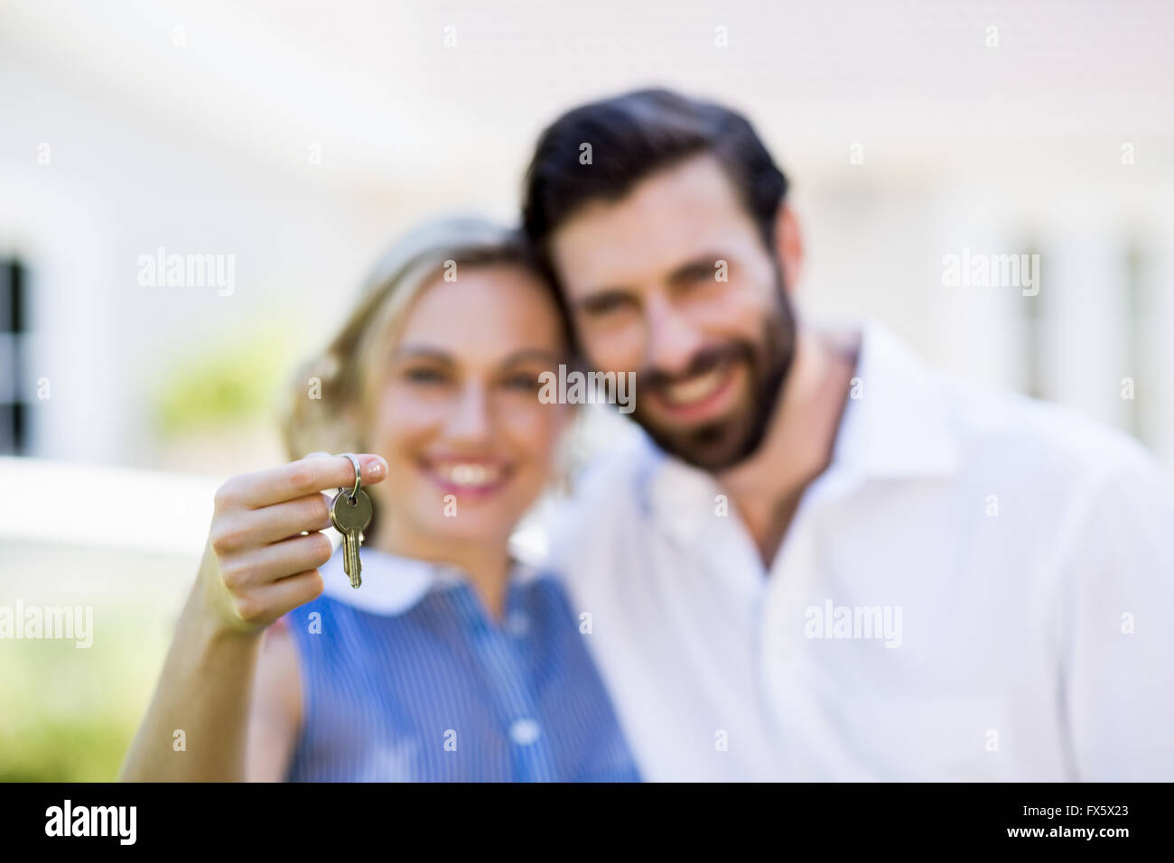 Couple holding house key Stock Photo - Alamy
