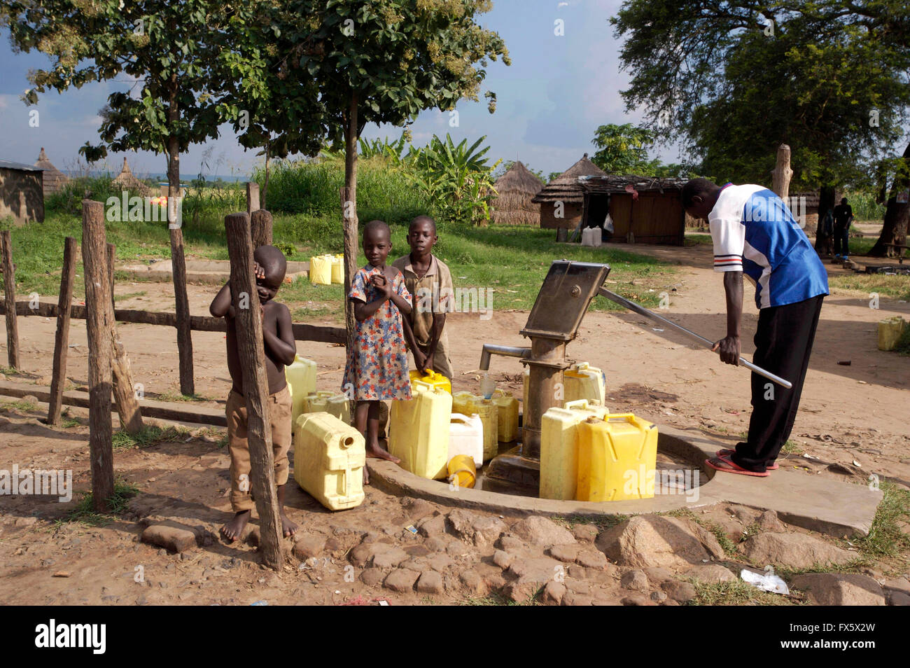 Gathering water from a well in Uganda, Africa Stock Photo - Alamy