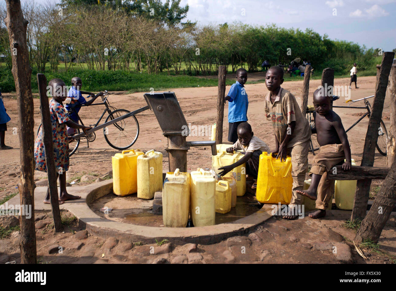 Children gathering water from a well in Uganda, Africa Stock Photo - Alamy