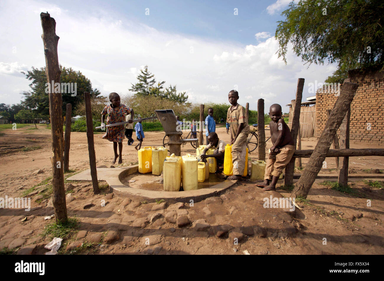 Children gathering water from a well in Uganda, Africa Stock Photo - Alamy