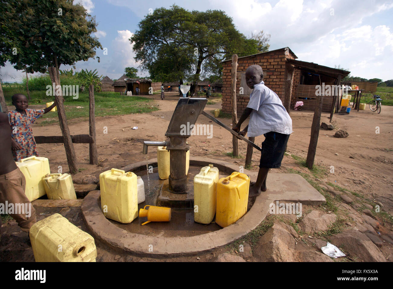 Child gathering water from a well in Uganda, Africa Stock Photo - Alamy