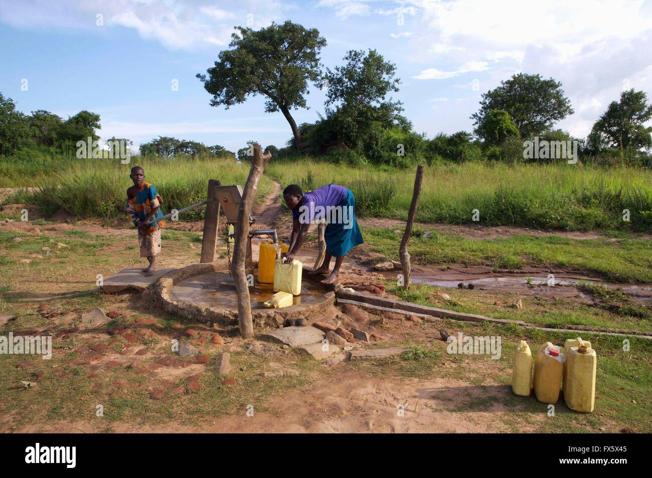Mother and daughter gathering water from a well in Uganda, Africa Stock ...
