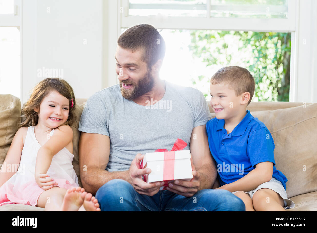 Father receiving a gift from his kids Stock Photo - Alamy