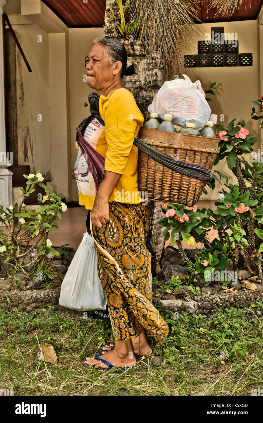 A Javanese woman seller of jamu, traditional Indonesian medicine, which ...