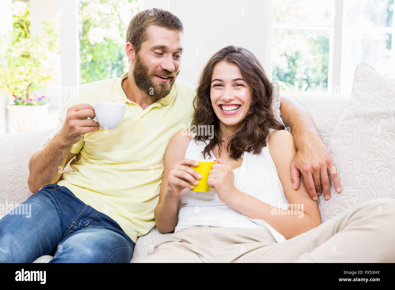 Couple having fun while drinking coffee Stock Photo - Alamy