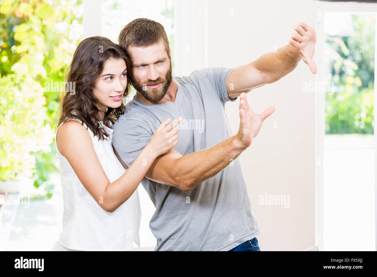 Couple framing a picture with hands Stock Photo - Alamy