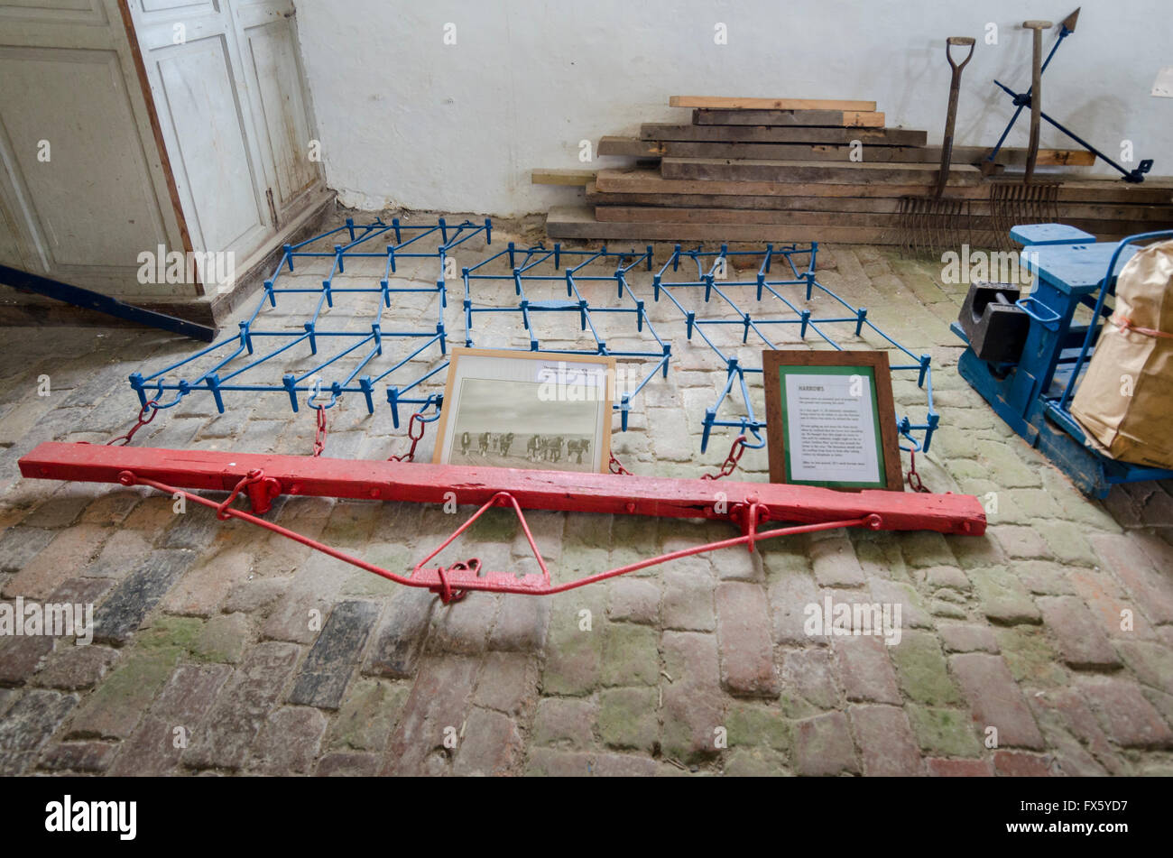 Ancient harrow on display on a brick floor Stock Photo - Alamy
