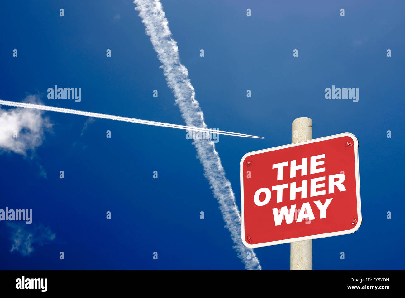 The other way sign with jet trails crossing in a dark blue sky Stock ...