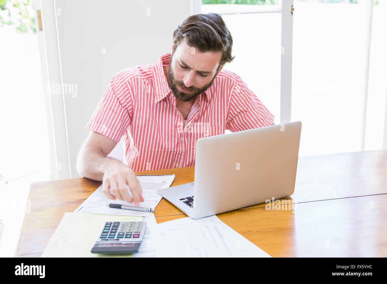 Young man calculating his bills Stock Photo - Alamy