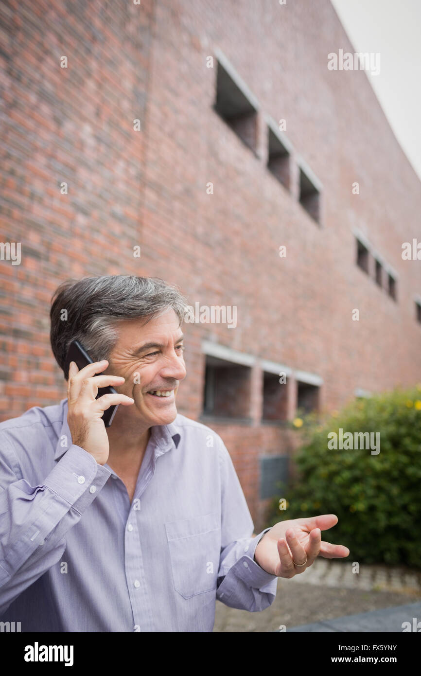 Happy professor talking on phone Stock Photo - Alamy