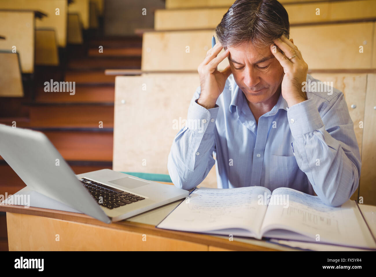 Sad teacher sitting on desk hi-res stock photography and images - Alamy