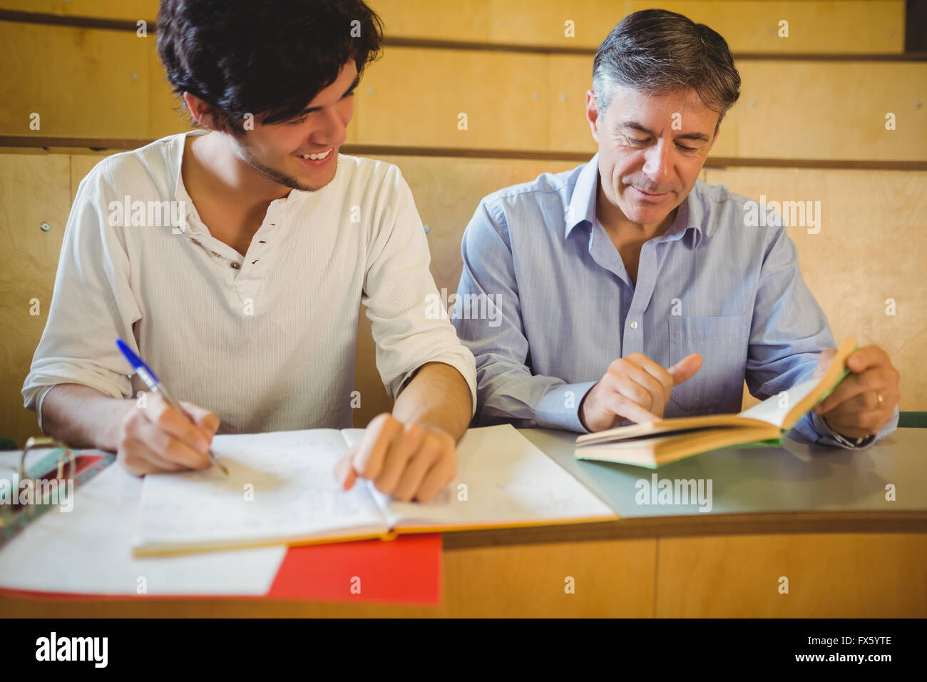 Professor assisting a student with his study Stock Photo - Alamy