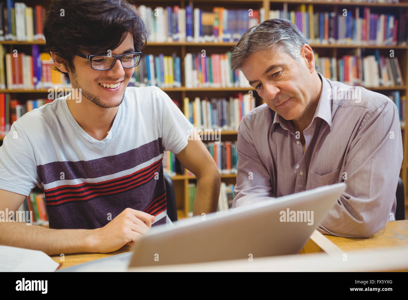 Professor assisting a student with studies Stock Photo - Alamy