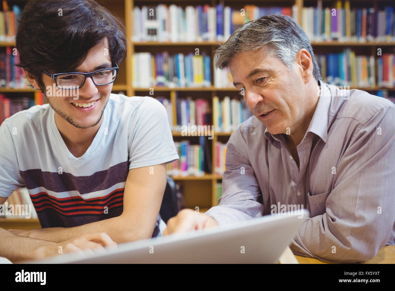 Professor assisting a student with studies Stock Photo - Alamy