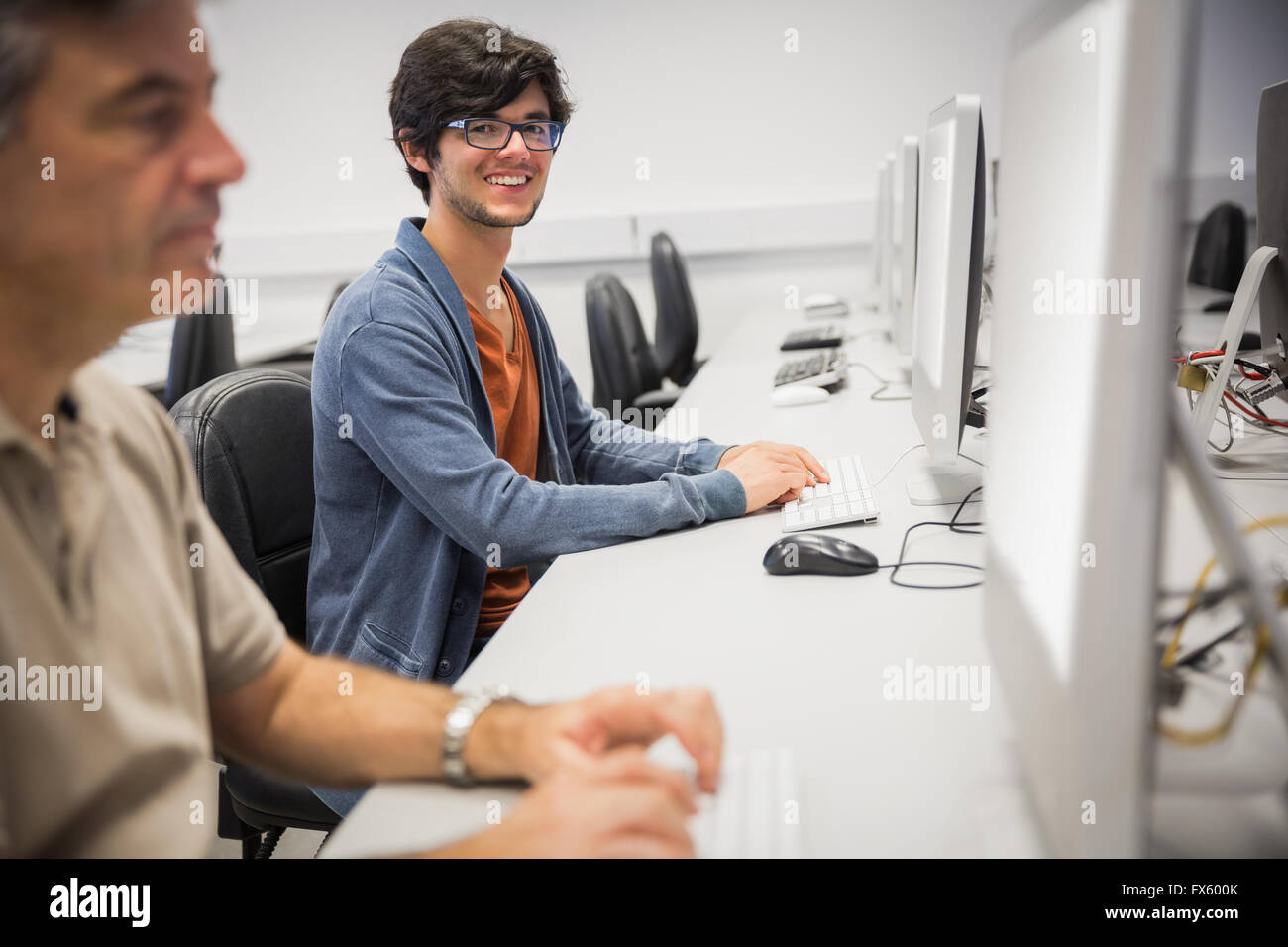 Portrait of happy student using computer Stock Photo - Alamy