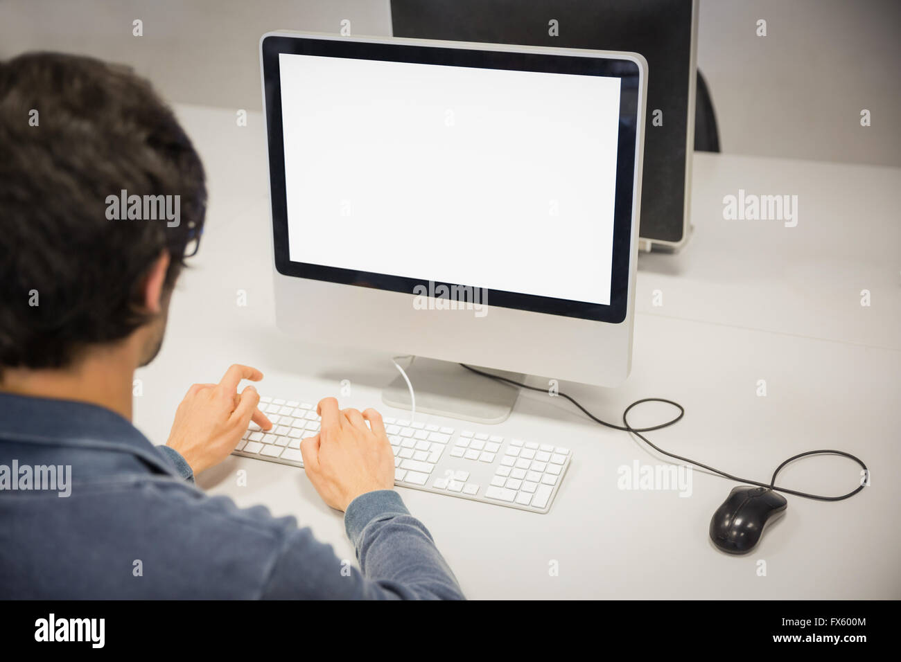Rear view of student using computer Stock Photo - Alamy