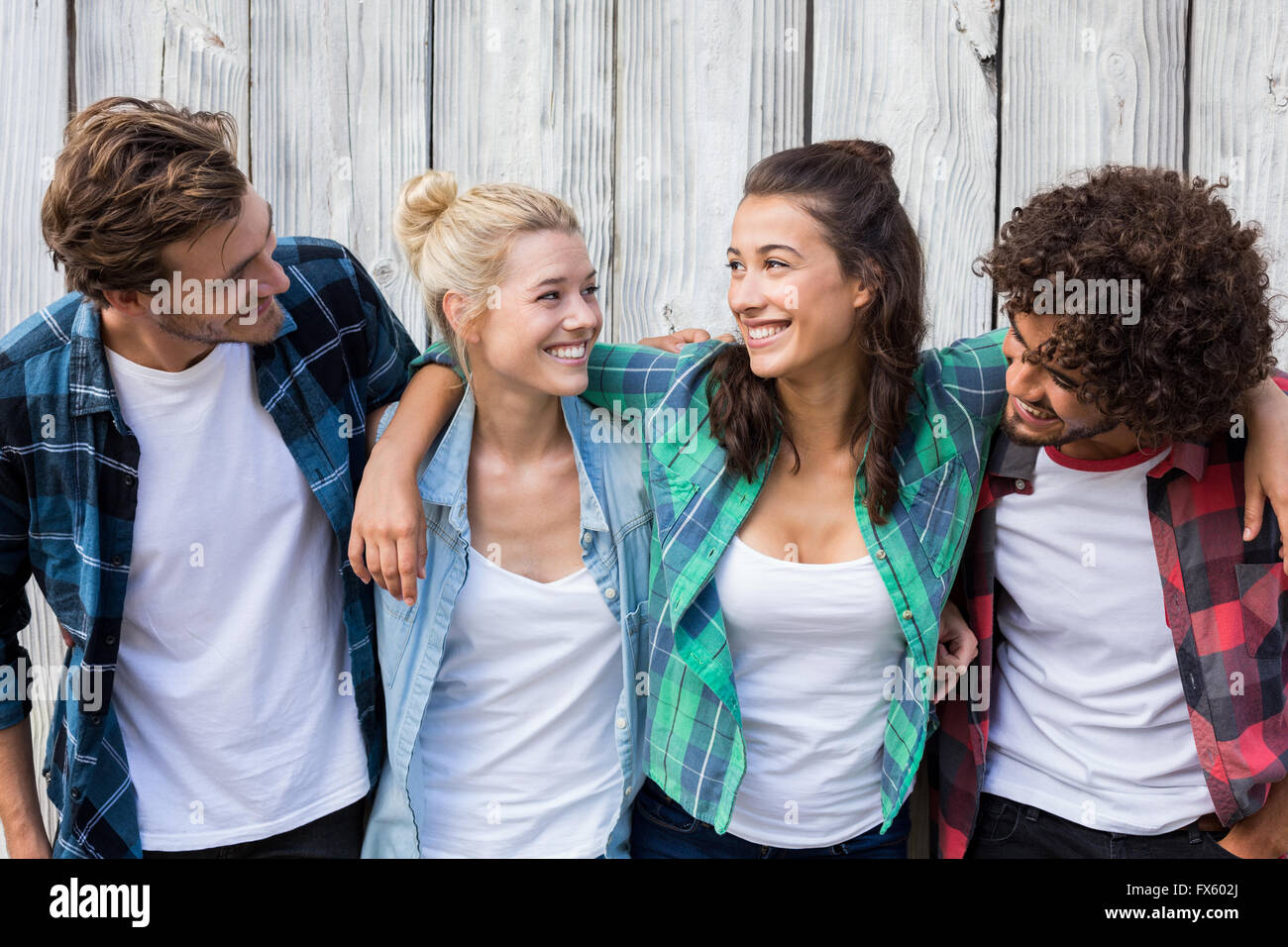 Friends standing with arms around Stock Photo - Alamy