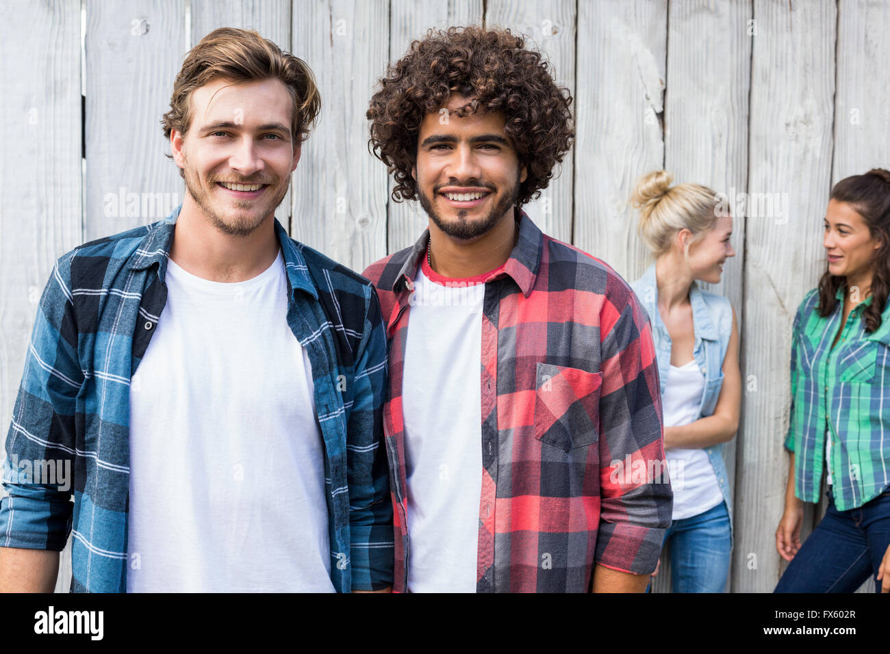 Young men smiling at camera Stock Photo - Alamy