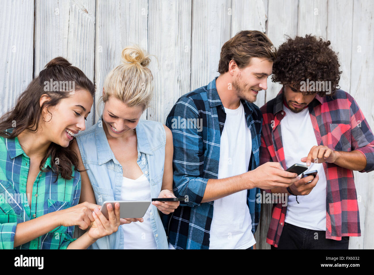 Friends using mobile phone Stock Photo - Alamy