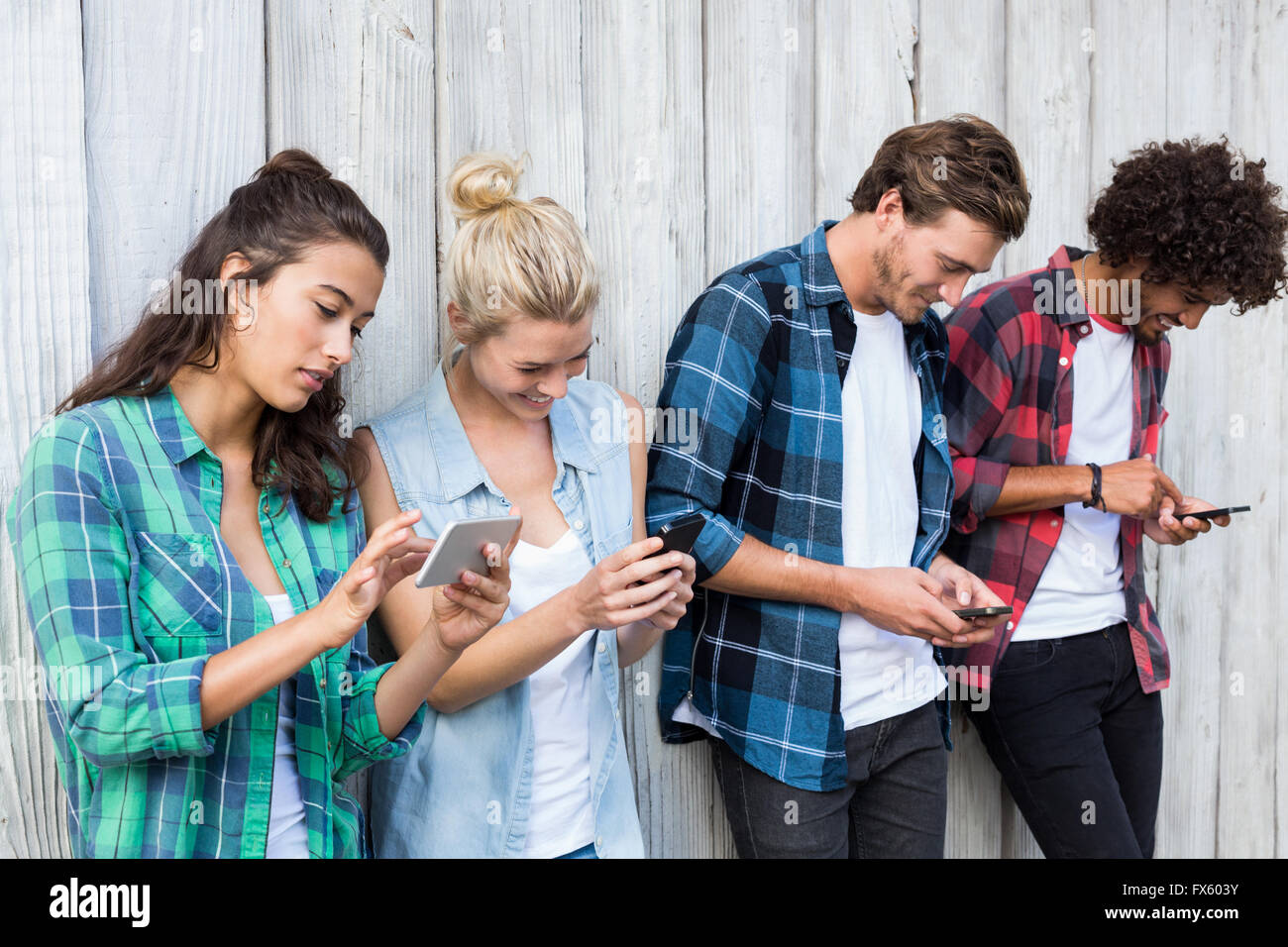Friends using mobile phone Stock Photo - Alamy