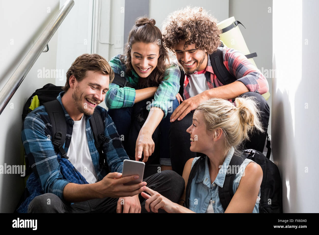 Man showing mobile phone to his friends Stock Photo - Alamy