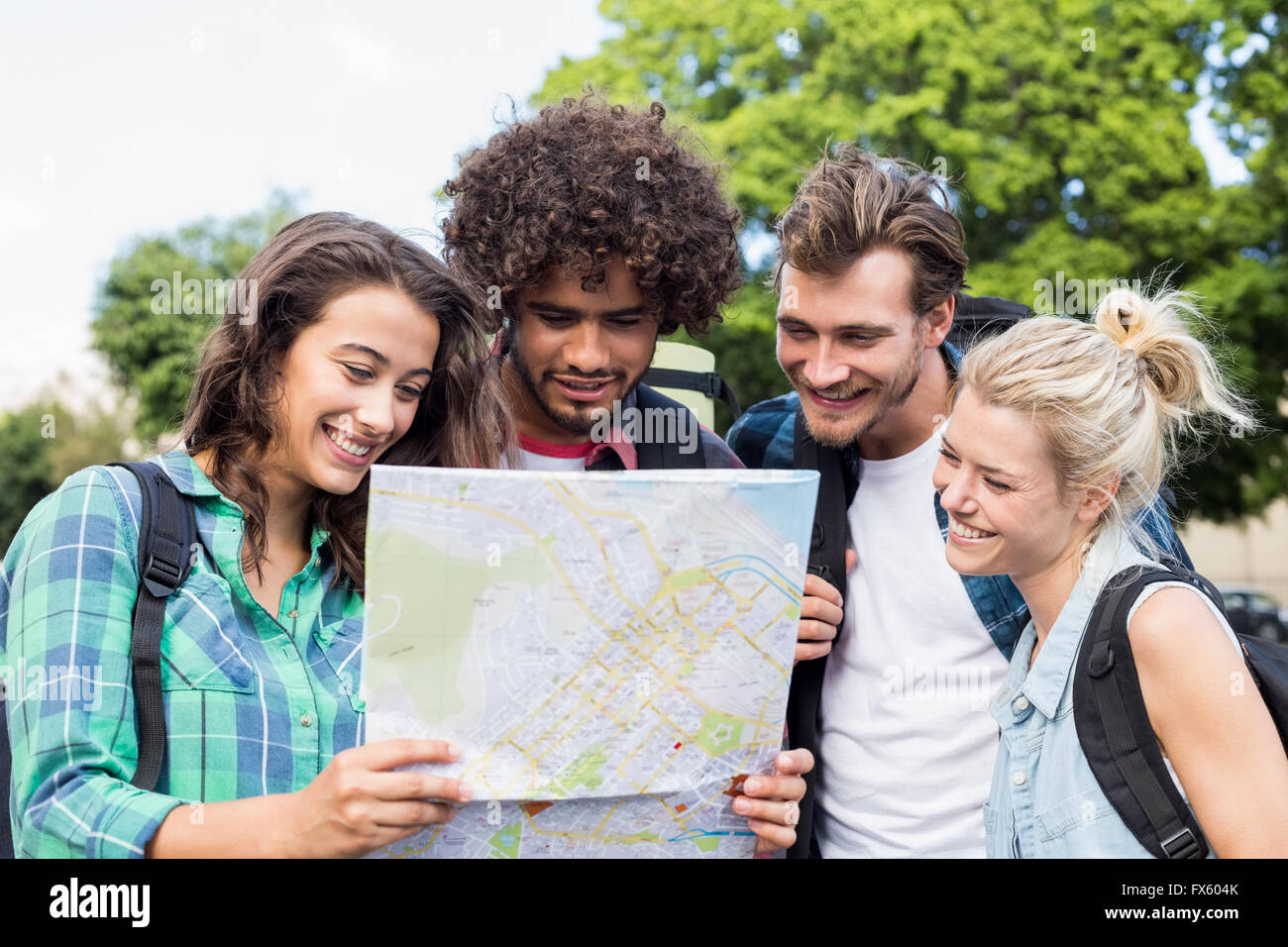 Friends looking at map Stock Photo - Alamy