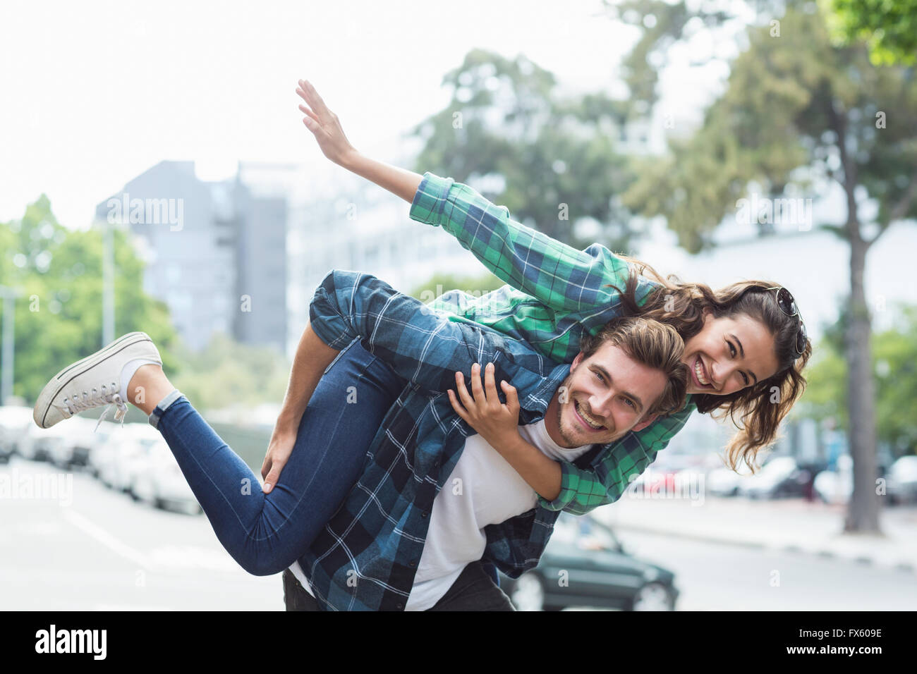 Man giving piggyback to woman Stock Photo - Alamy