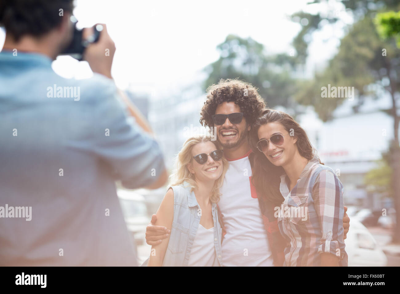 Man taking photo of his friends Stock Photo - Alamy