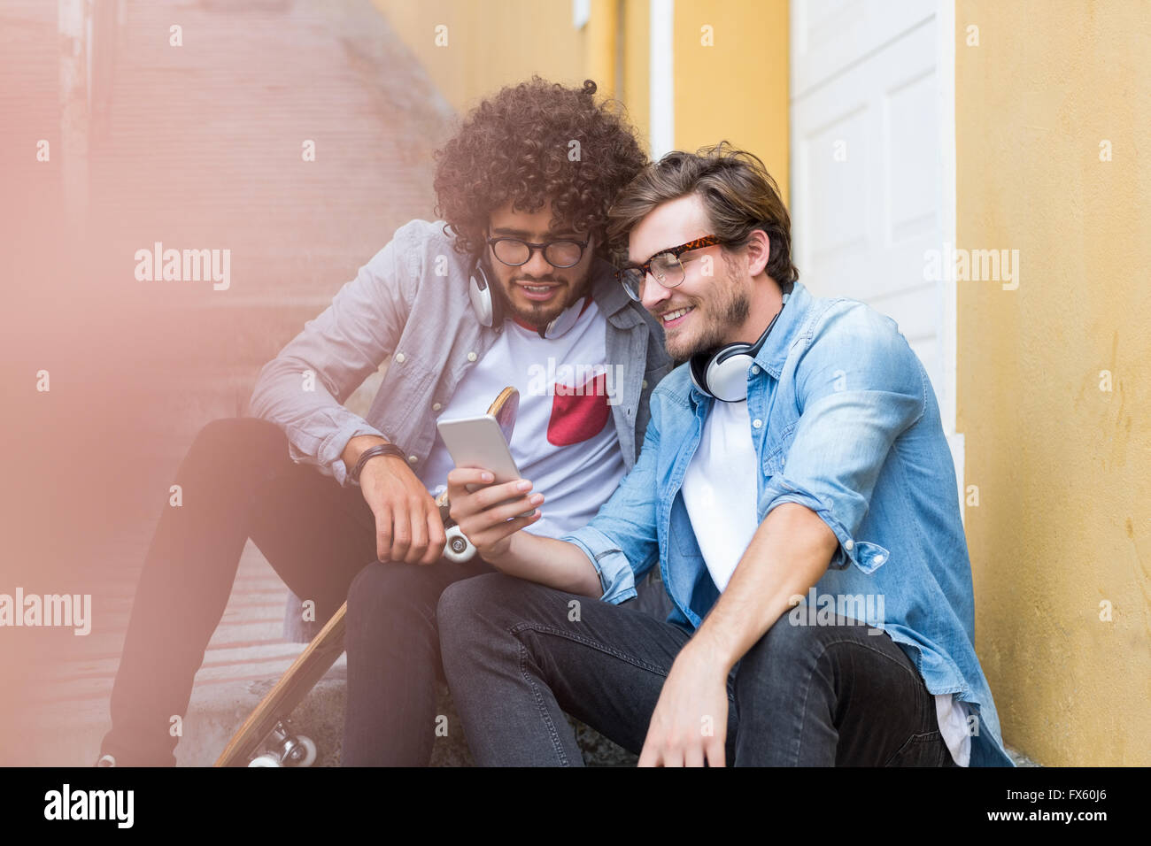 Friends using mobile phone Stock Photo - Alamy