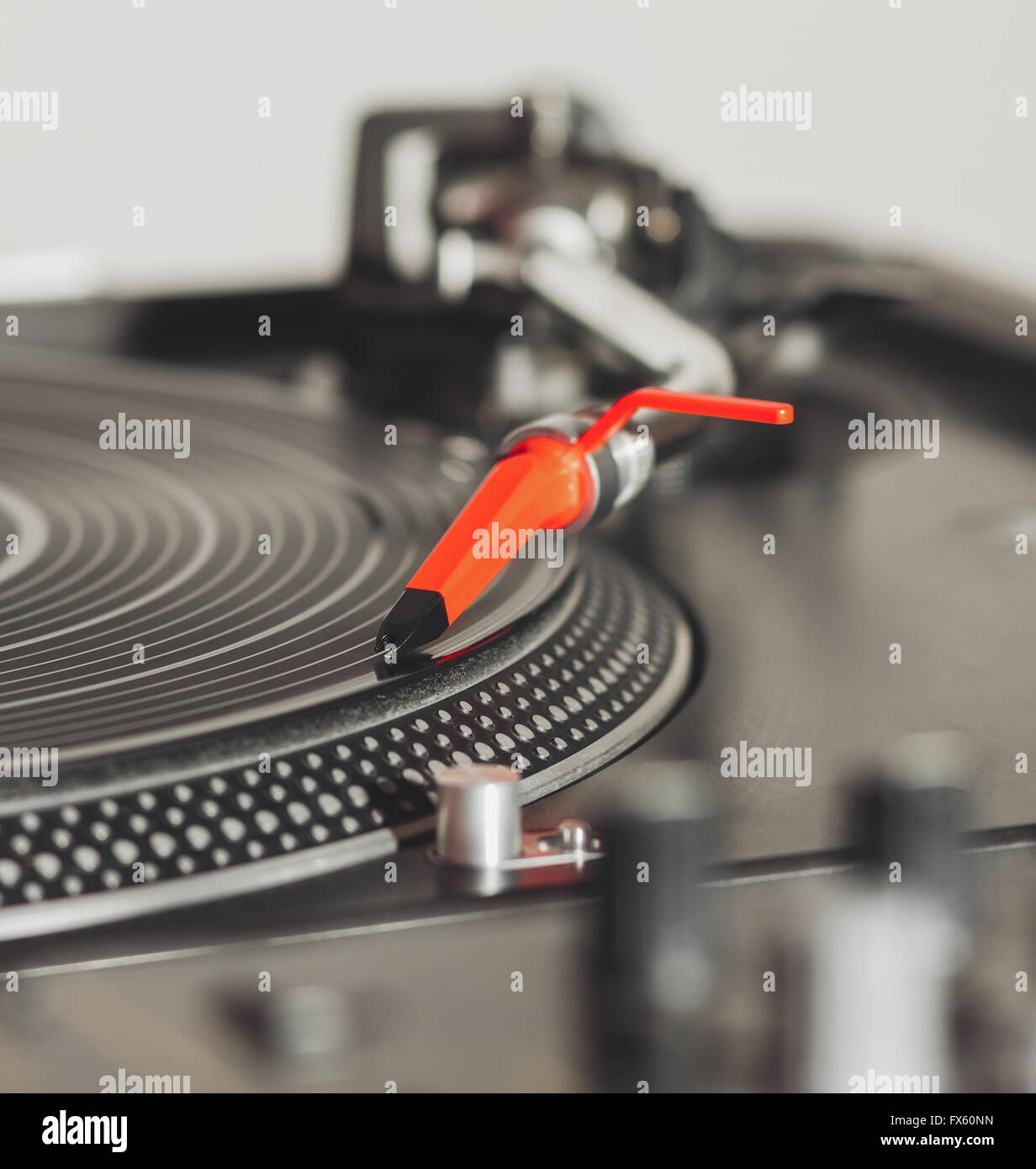 Turntable playing analog audio vinyl disc with music. Close up on ...