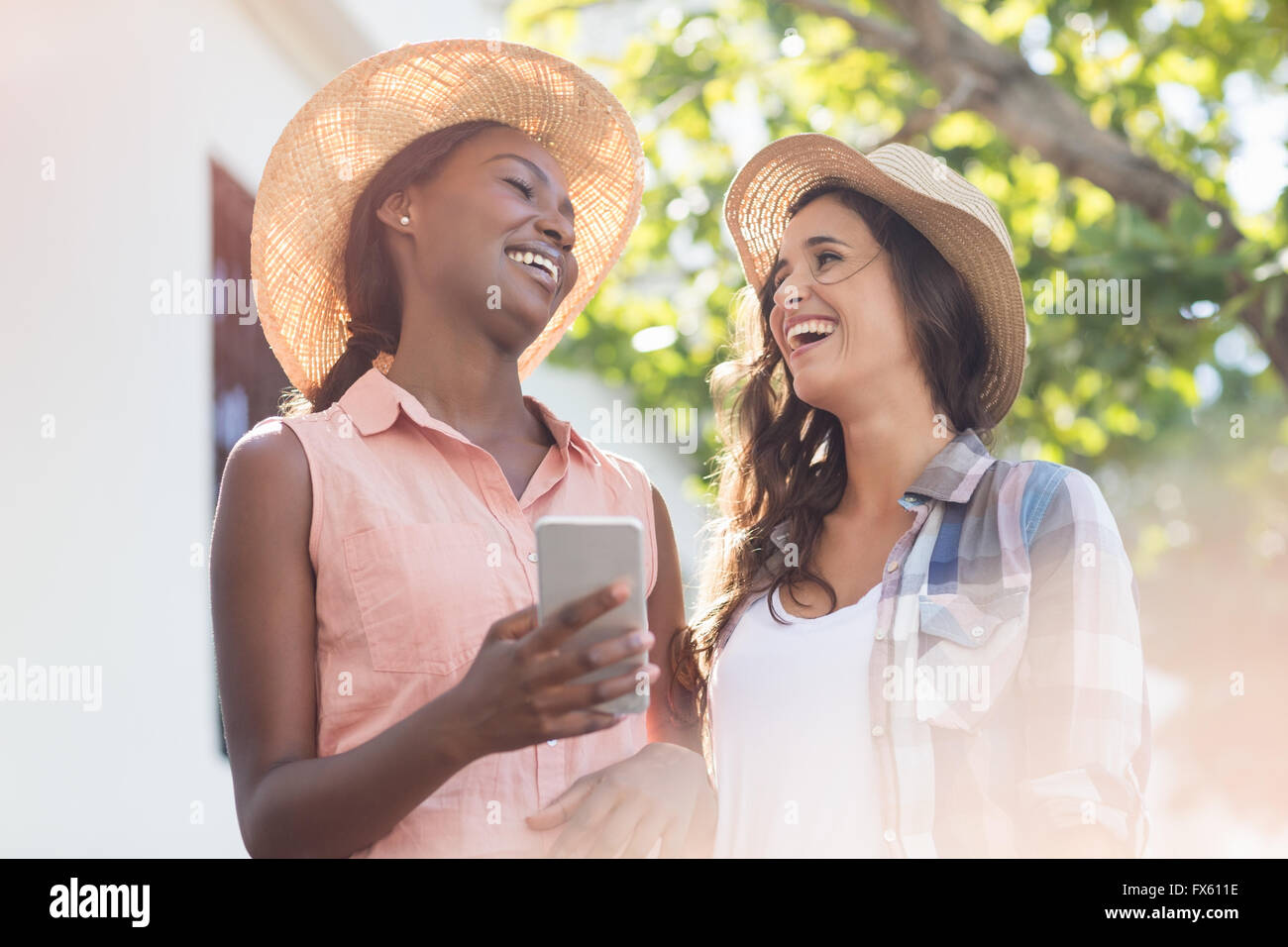 Young women using mobile phone Stock Photo - Alamy