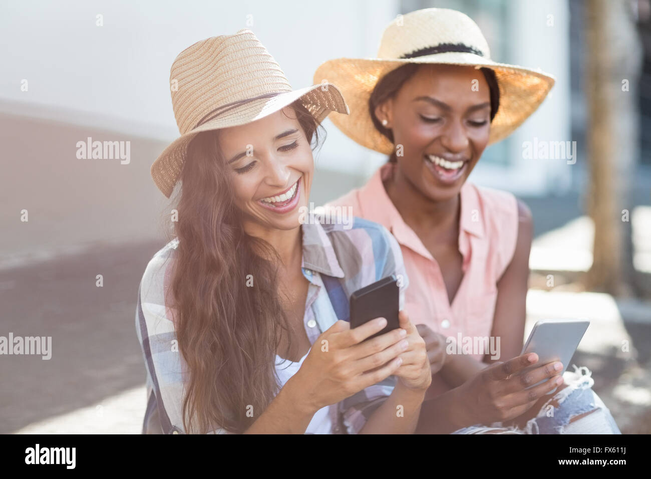 Young women using mobile phone Stock Photo - Alamy