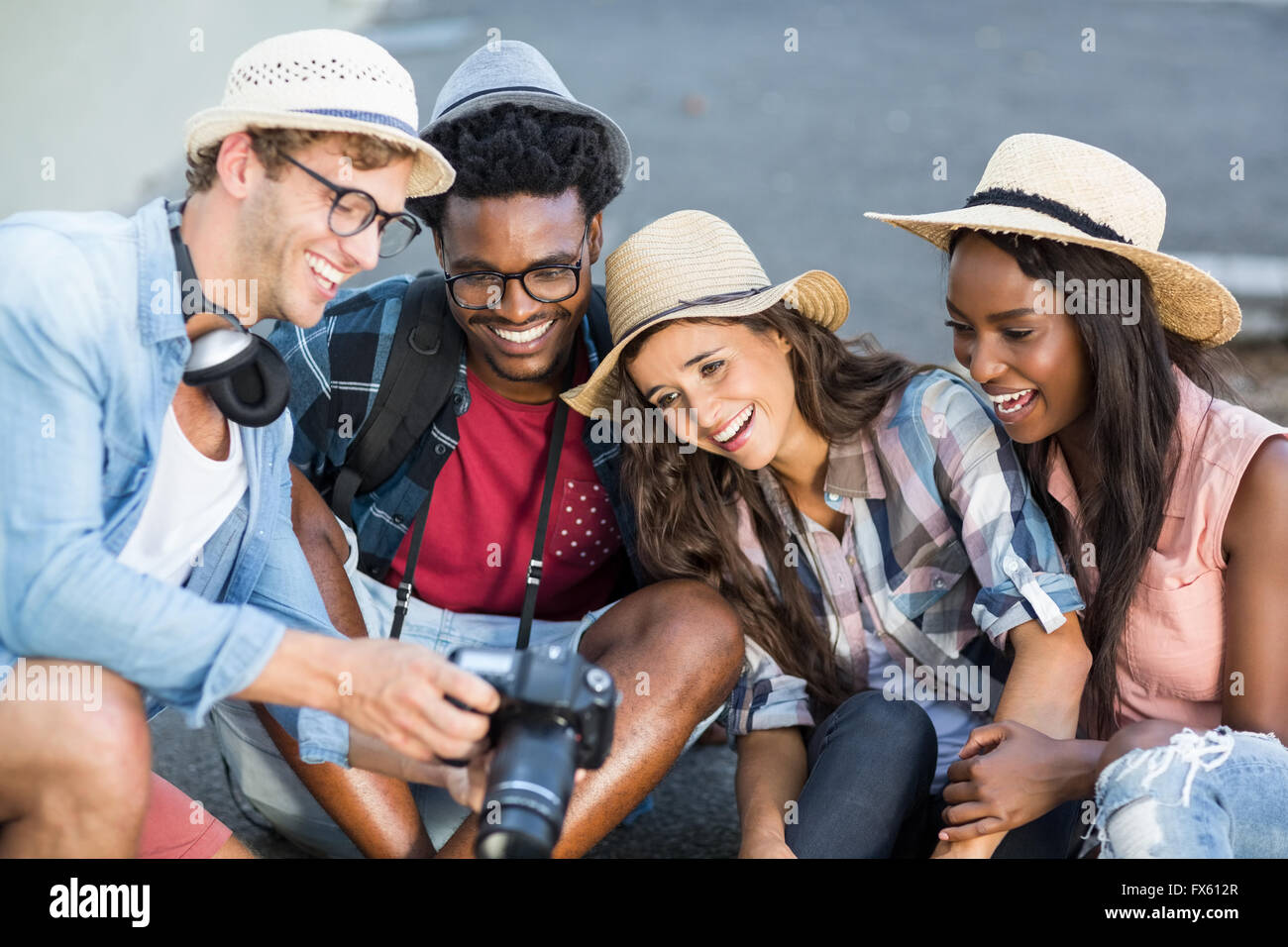 Man showing photos in camera to his friends Stock Photo - Alamy