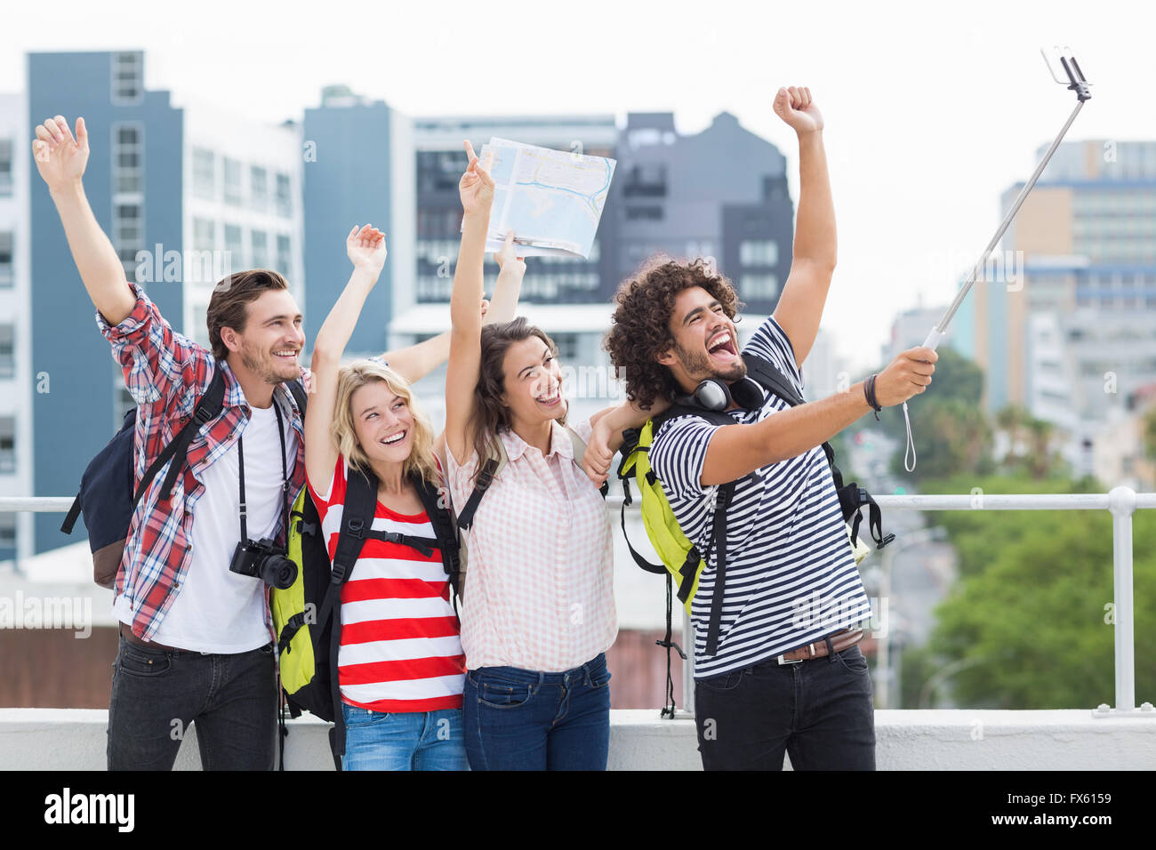 Group of friends taking selfie with selfie stick Stock Photo - Alamy