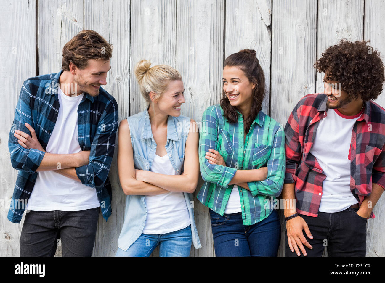 Friends leaning with arms crossed Stock Photo - Alamy
