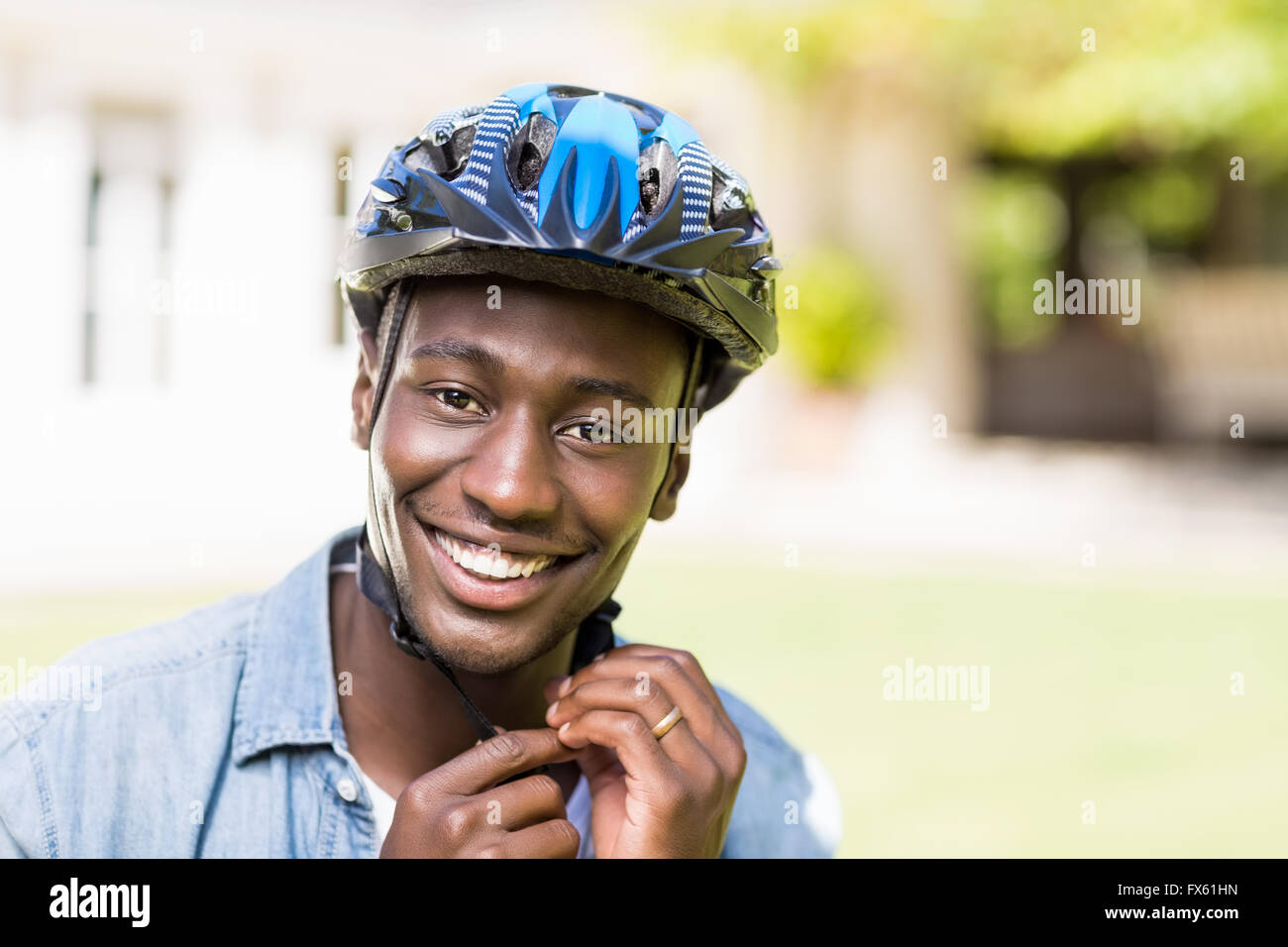 Happy man wearing his helmet Stock Photo - Alamy