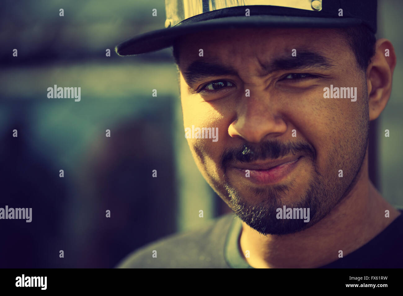 Portrait of handsome young african man in snap back baseball cap posing ...