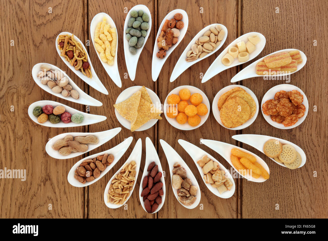 Savory snack party food selection in porcelain dishes over oak ...
