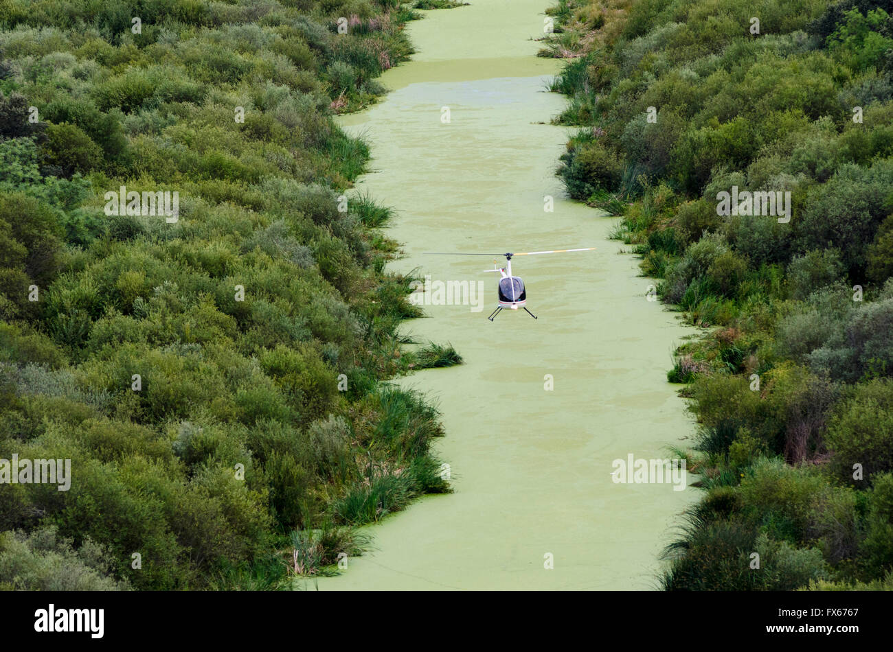 Aerial view of helicopter flying over remote river Stock Photo - Alamy