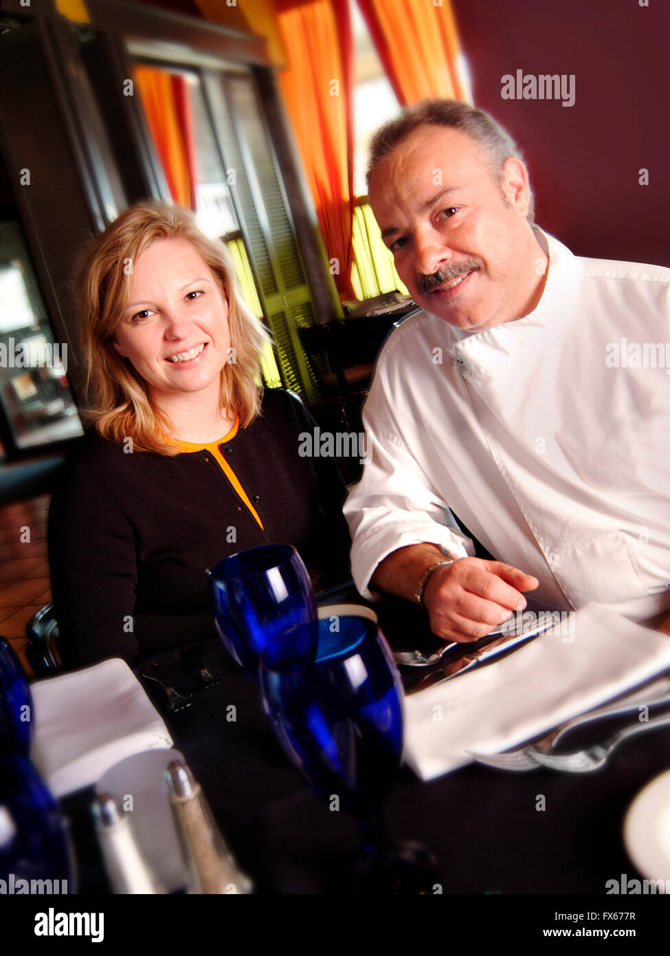 Chef and restaurant owner smiling Stock Photo - Alamy