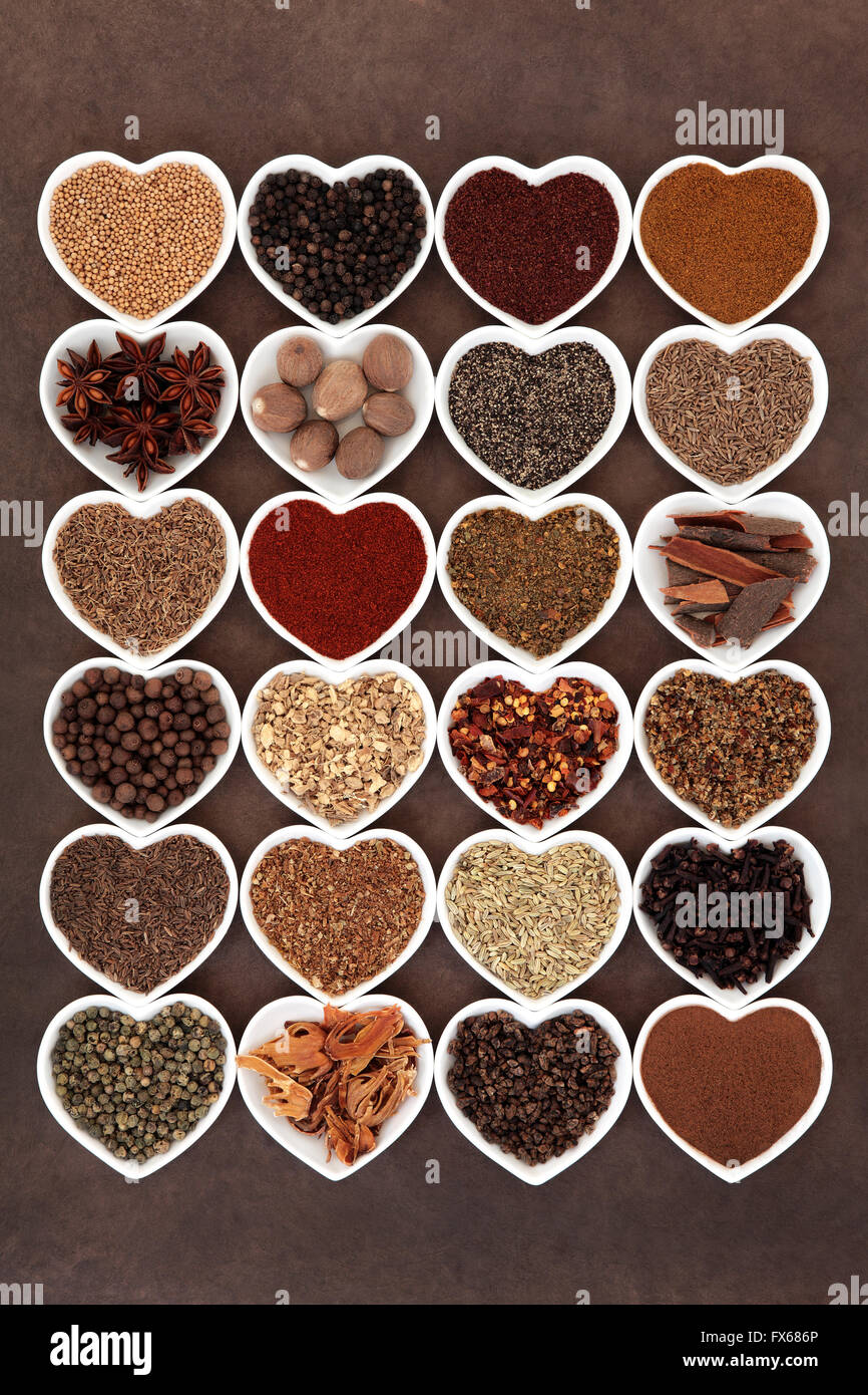 Large spice collection in heart shaped porcelain dishes over lokta ...